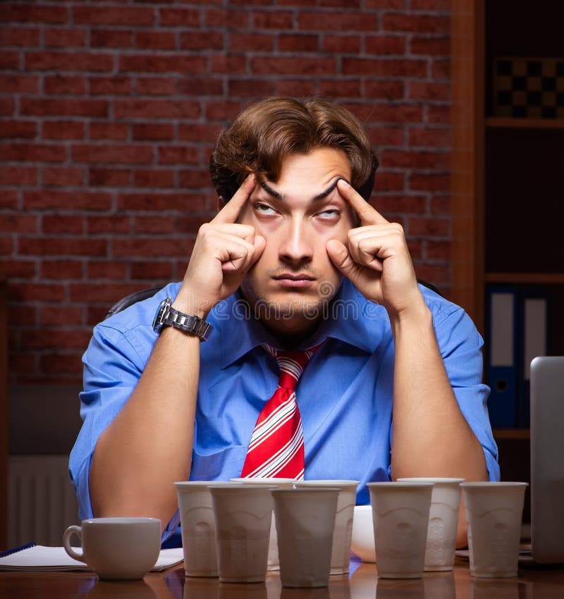 Young Employee Drinking Coffee Working at Night Shift Stock Photo ...