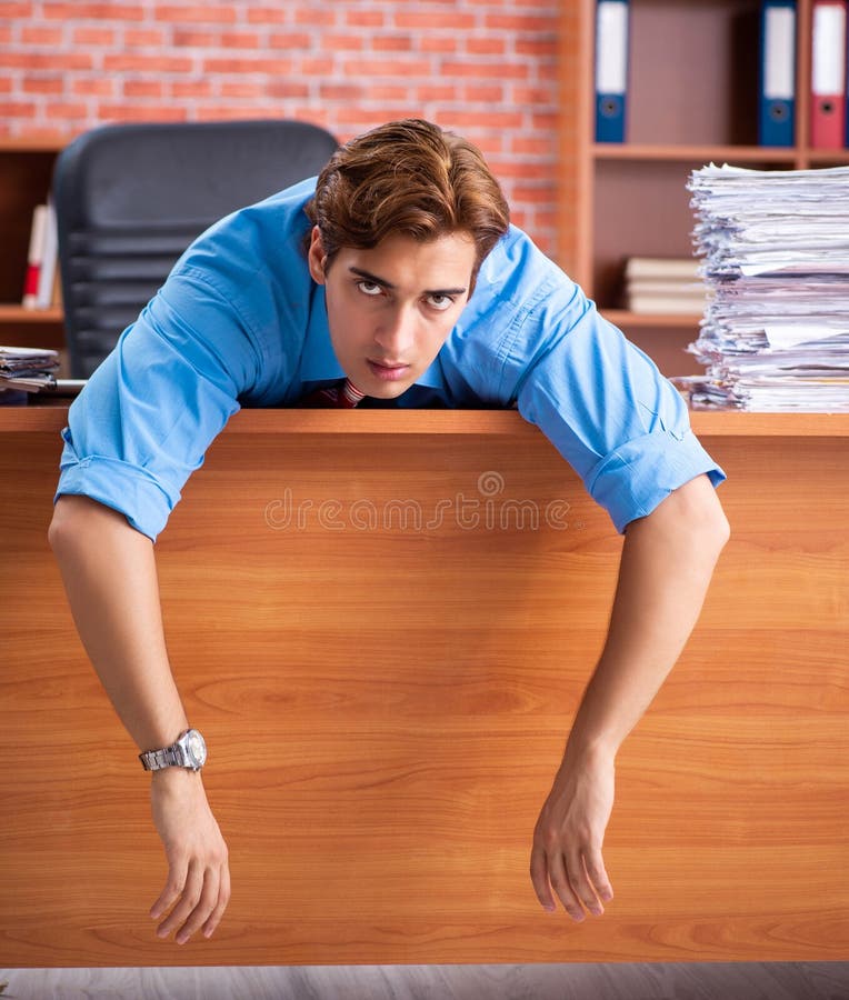 Young Employee with Excessive Work Sitting at the Office Stock Image ...