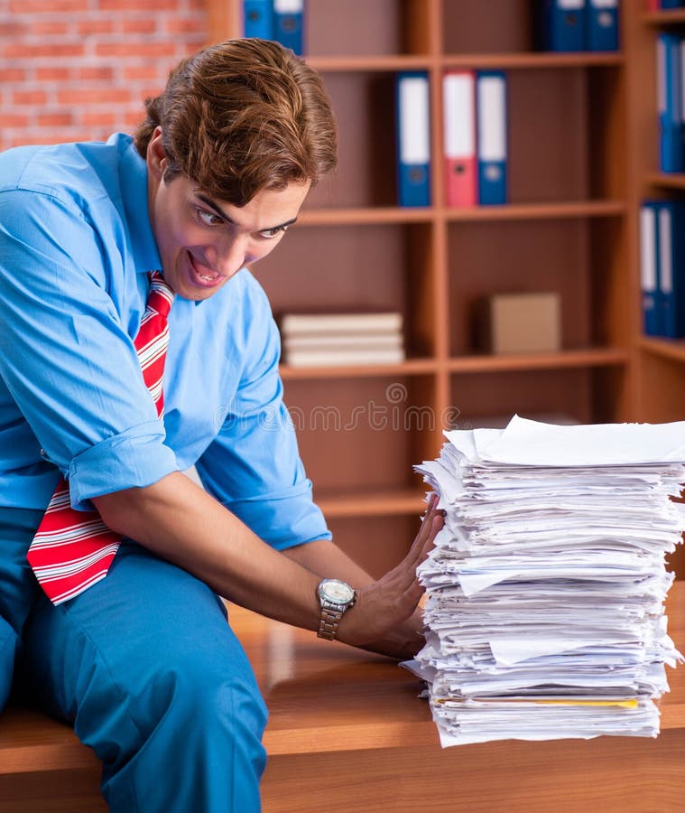 Young Employee with Excessive Work Sitting at the Office Stock Image ...