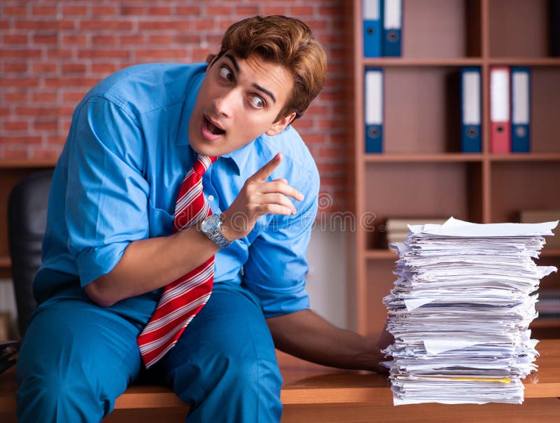 Young Employee with Excessive Work Sitting at the Office Stock Photo ...