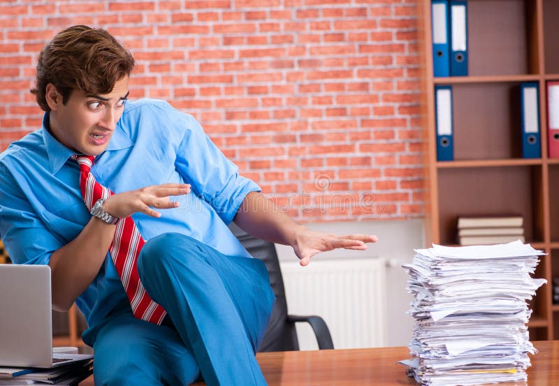 Young Employee with Excessive Work Sitting at the Office Stock Image ...