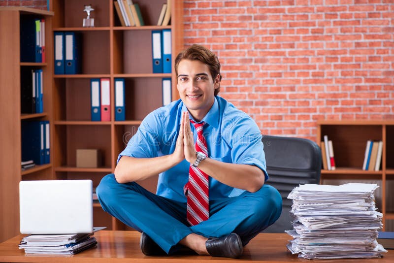 The Young Employee with Excessive Work Sitting at the Office Stock ...
