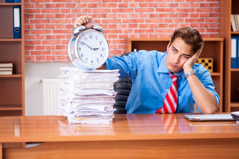 The Young Employee with Excessive Work Sitting at the Office Stock ...
