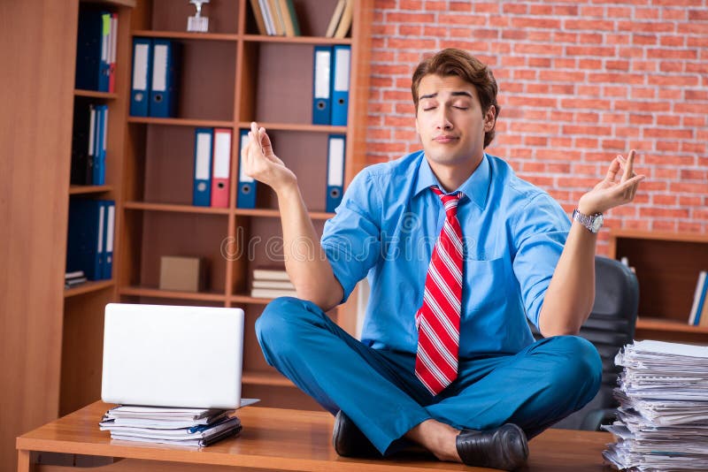 The Young Employee with Excessive Work Sitting at the Office Stock ...