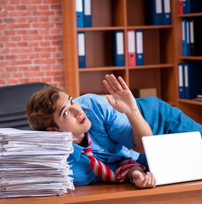 Young Employee with Excessive Work Sitting at the Office Stock Image ...