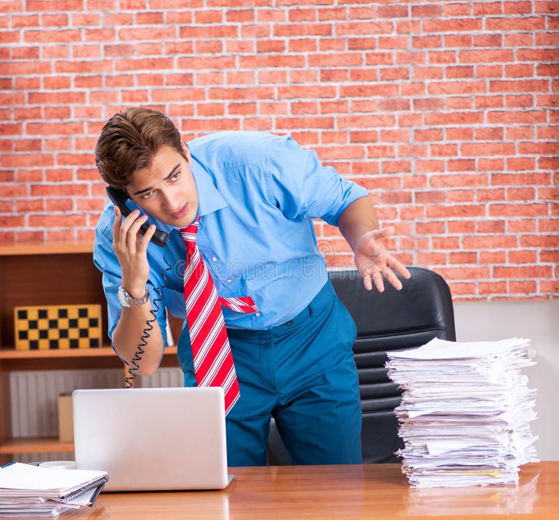 Young Employee with Excessive Work Sitting at the Office Stock Image ...