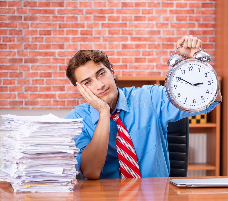 Young Employee with Excessive Work Sitting at the Office Stock Photo ...