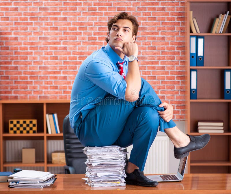 Young Employee with Excessive Work Sitting at the Office Stock Photo ...
