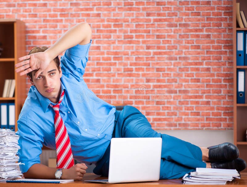 Young Employee with Excessive Work Sitting at the Office Stock Image ...