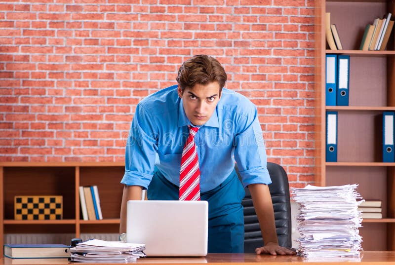 Young Employee with Excessive Work Sitting at the Office Stock Image ...