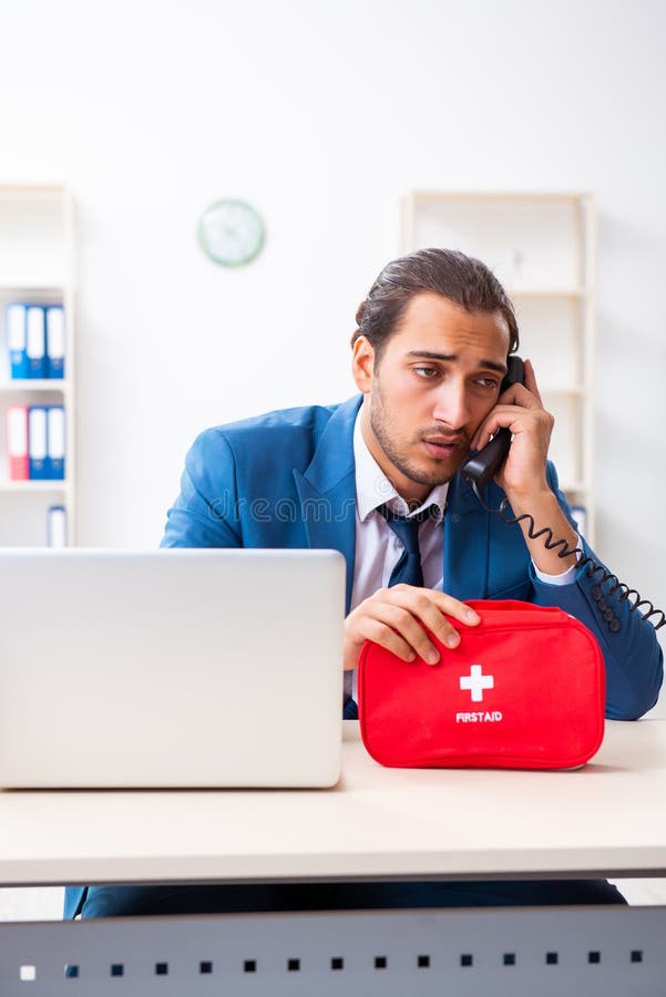 Young Male Employee in First Aid Concept Stock Photo - Image of ...