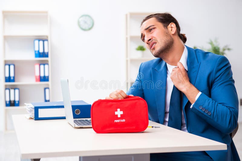 Young Male Employee in First Aid Concept Stock Image - Image of manager ...