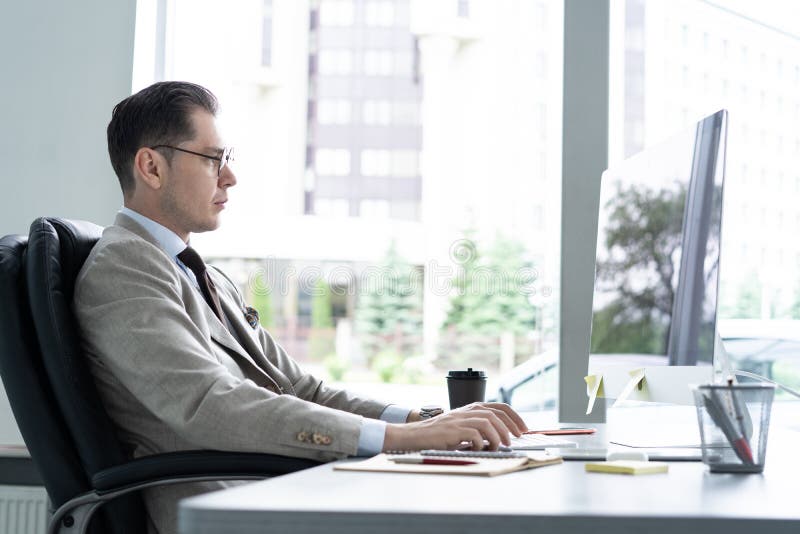 Young Employee Looking at Computer Monitor during Working Day in Office ...
