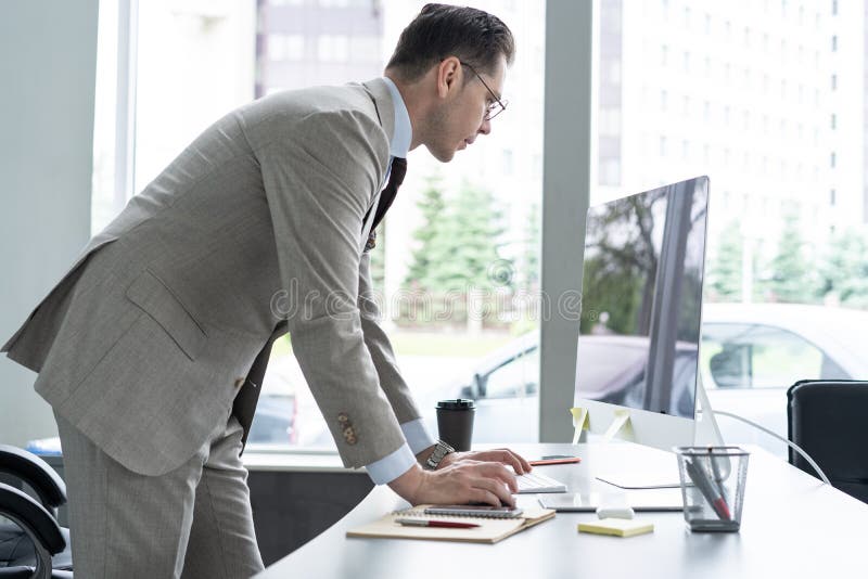 Young Employee Looking at Computer Monitor during Working Day in Office ...