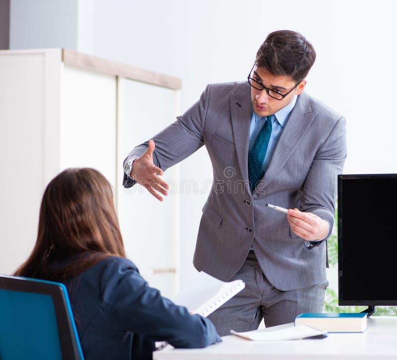 Young Employee Making Presentation To His Female Boss Stock Image ...