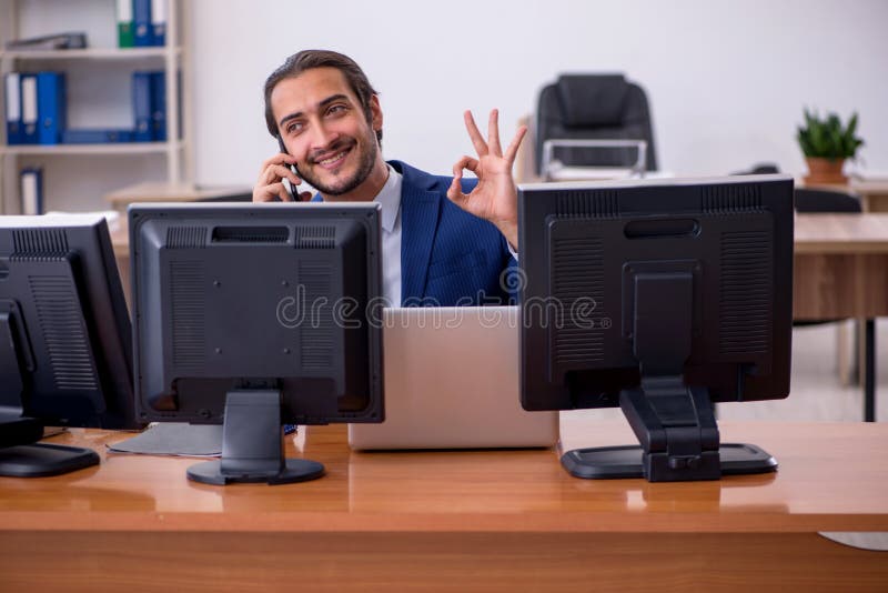Young Male Employee in Multitasking Concept Stock Image - Image of ...