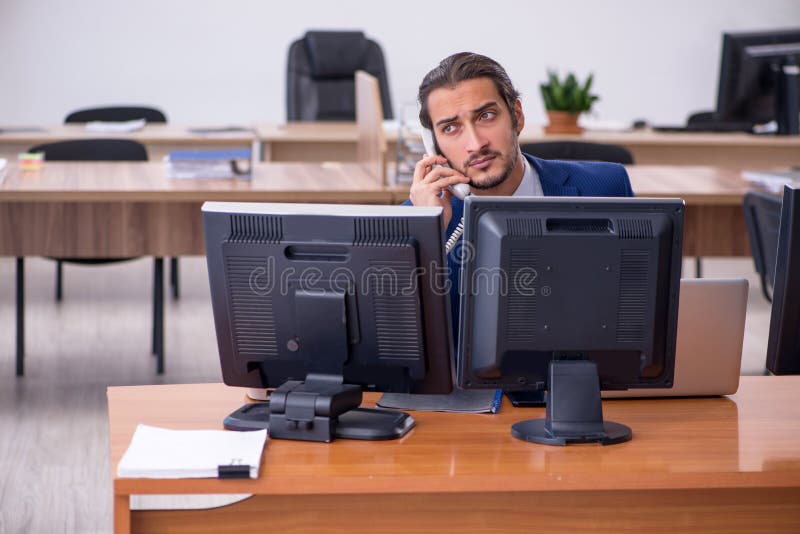 Young Male Employee in Multitasking Concept Stock Photo - Image of ...