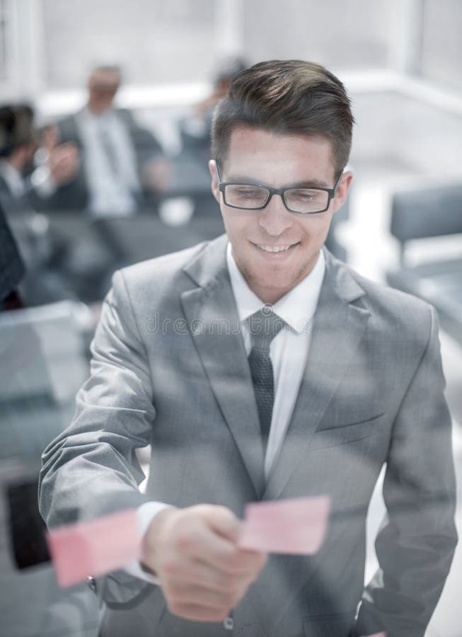 Young Employee Reading a Note on the Glass. Stock Image - Image of male ...