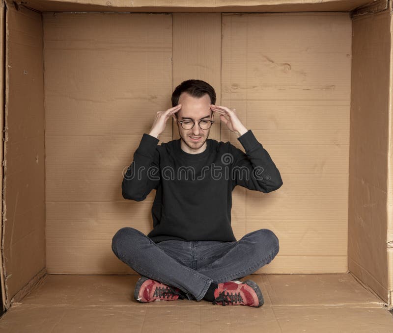 Young Employee Sitting in a Small Cramped Office, Getting Ready To Work ...