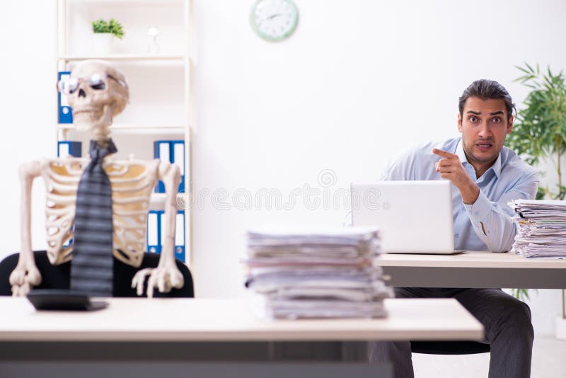 Young Male Employee and Skeleton in the Office Stock Image - Image of ...