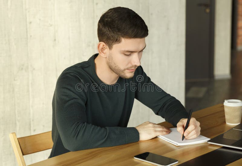 Young Employee Taking Notes Sitting in Modern Office Stock Image ...