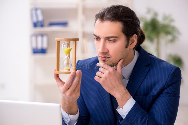 Young Male Employee in Time Management Concept Stock Image - Image of ...
