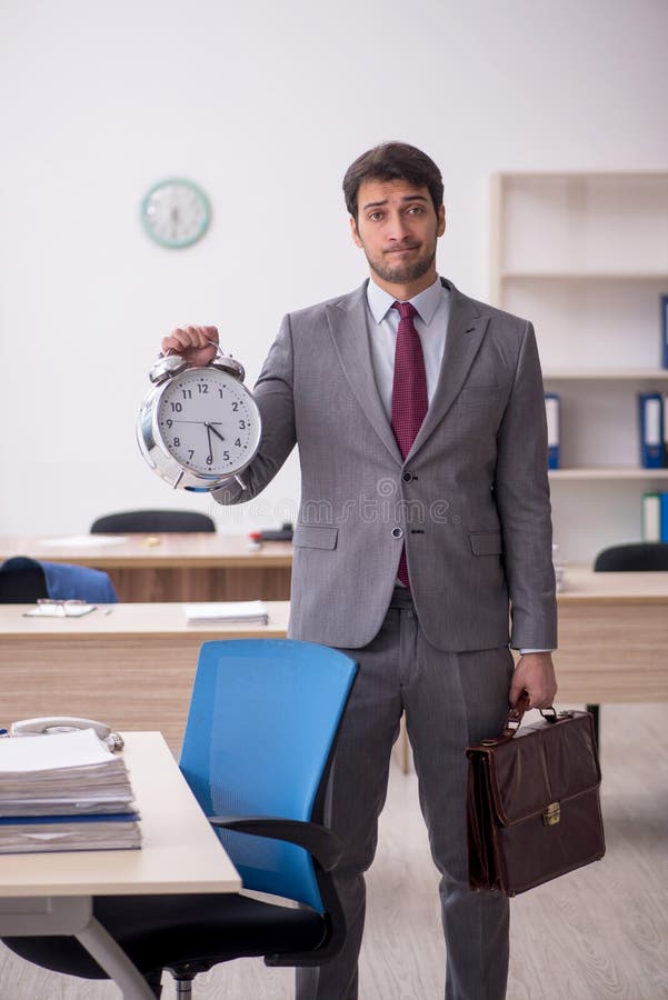 Young Male Employee in Time Management Concept Stock Photo - Image of ...