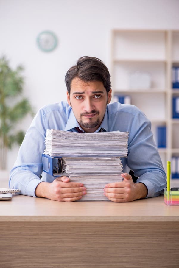 Young Male Employee and Too Much Work in the Office Stock Image - Image ...