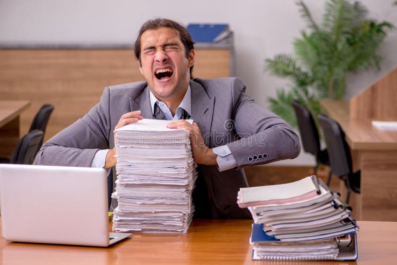 Young Male Employee and Too Much Work in the Office Stock Image - Image ...