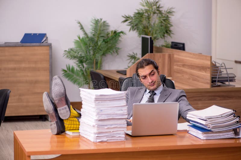 Young Male Employee and Too Much Work in the Office Stock Photo - Image ...