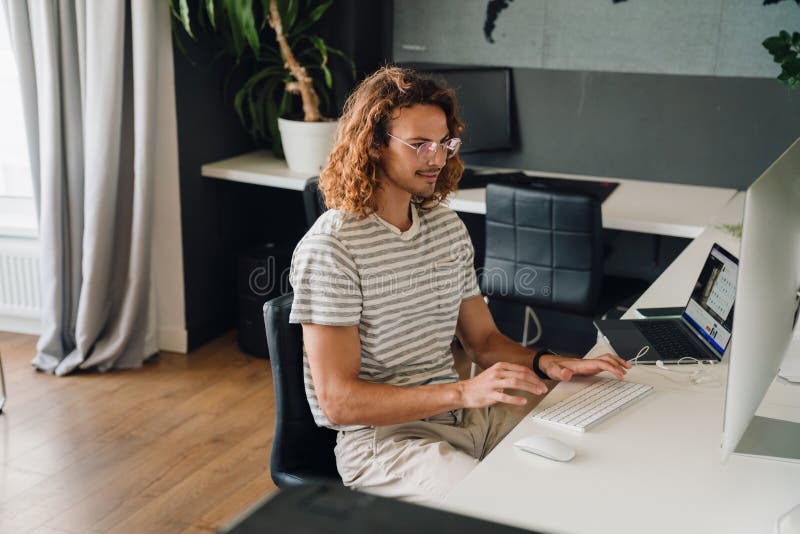 Young Employee Working on Desktop Computer in Office Stock Photo ...