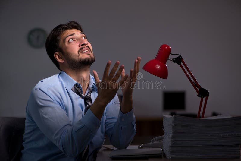 Young Male Employee Working Late in the Office Stock Photo - Image of ...