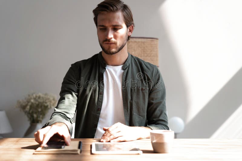 Young Employee at Workplace Using Mobile Phone, Checking Social Media ...