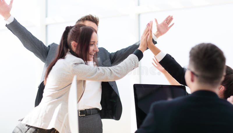 Young Employees Giving Each Other a High Five in the Workplace Stock ...
