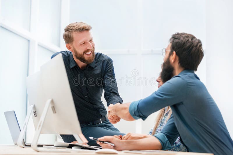 Young Employees Shaking Hands in the Workplace Stock Image - Image of ...