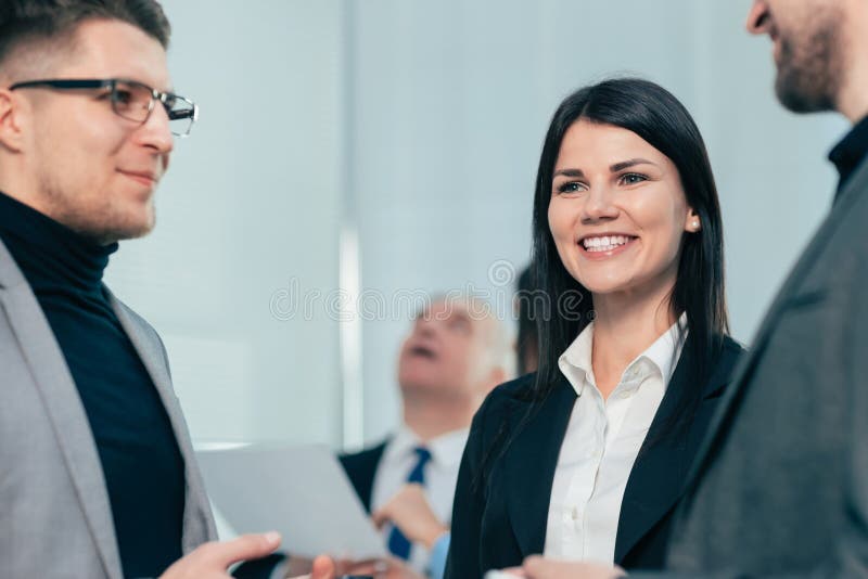 Young Employees Talk Standing in the Office. Stock Image - Image of ...