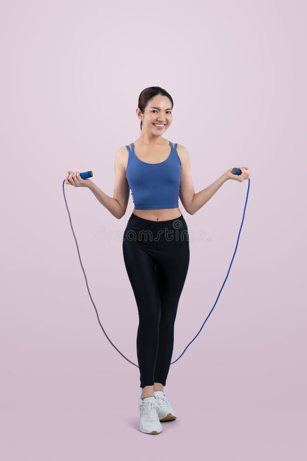 Young Energetic Asian Woman In Sportswear With Jumping Rope Vigorous
