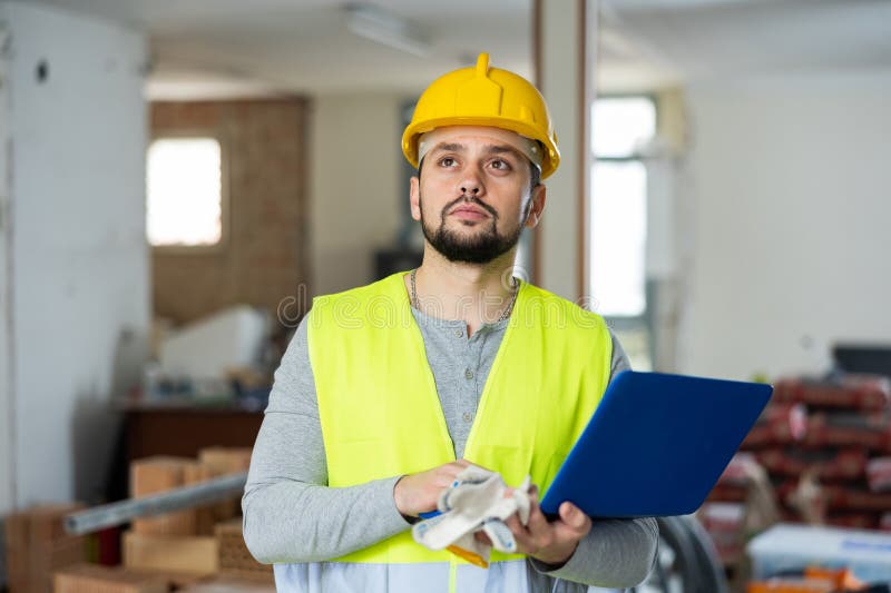Young Engineer Checking House Renovation Plan on Laptop Stock Photo ...