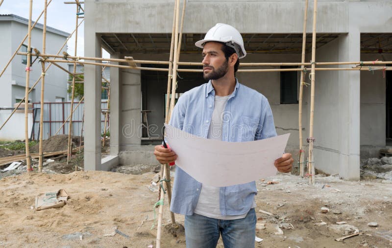 Young Engineer in a Construction Helmet Holding Work Calendar while ...