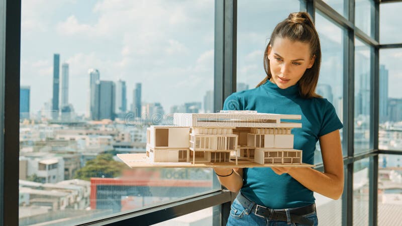Young Engineer Hold Architectural Model while Inspect House Model ...