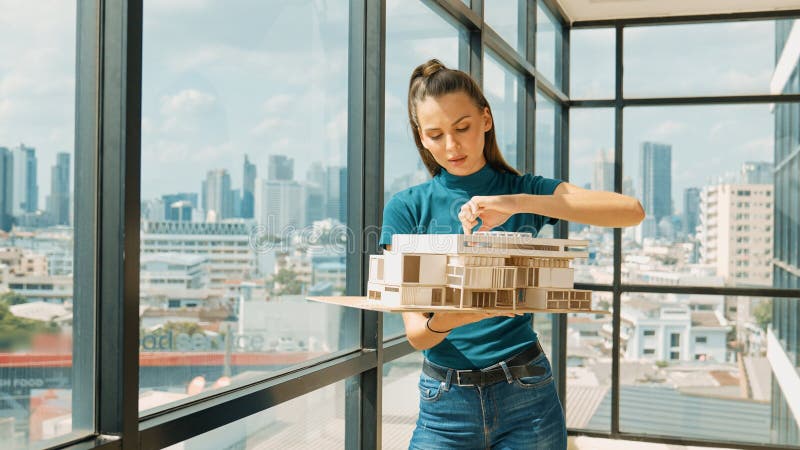 Young Engineer Hold Architectural Model while Inspect House Model ...