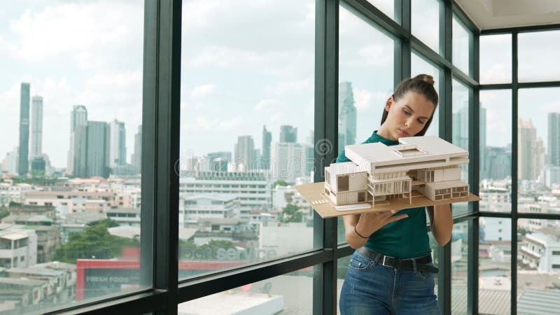 Young Engineer Hold Architectural Model while Inspect House Model ...