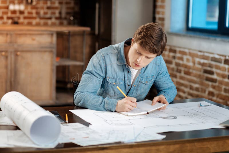 Young Engineer Making Notes Regarding His Project Stock Image - Image ...