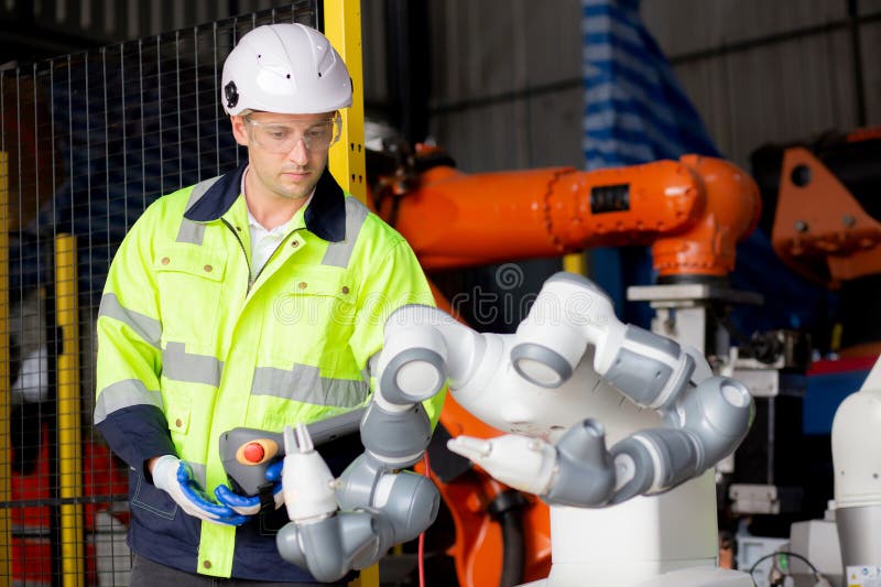 Young Engineer Man Checking and Maintenance Machine Robot Arms ...