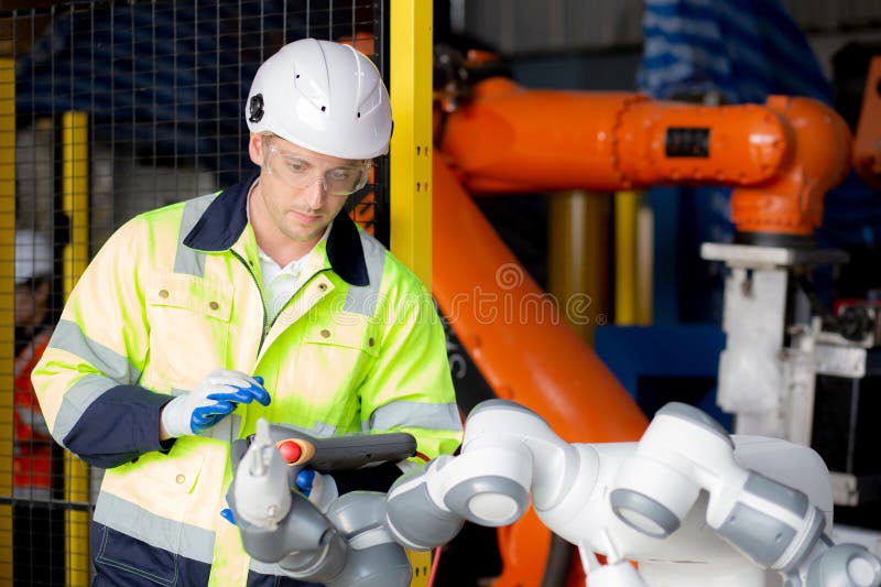 Young Engineer Man Checking and Maintenance Machine Robot Arms ...