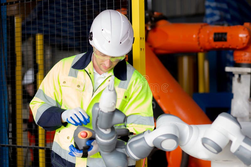 Young Engineer Man Checking and Maintenance Machine Robot Arms ...