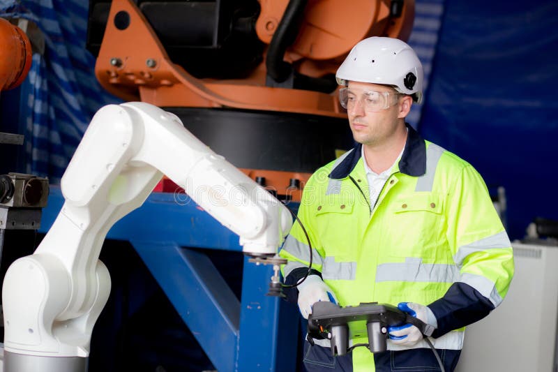 Young Engineer Man Checking and Maintenance Machine Robot Arms ...