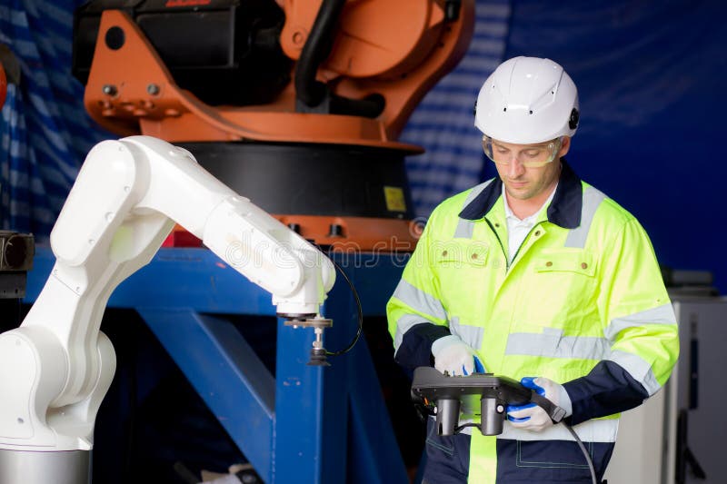 Young Engineer Man Checking and Maintenance Machine Robot Arms ...