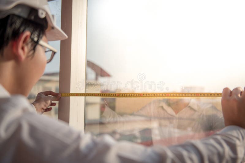 Young Engineer Man Using Measure Tape on Window Frame Stock Image ...