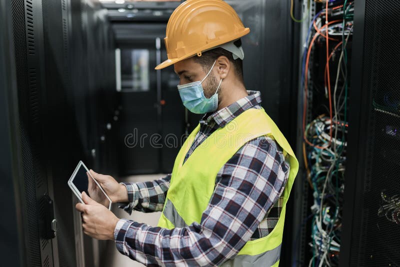 Young Engineer Man Working Inside Data Center Center Room while Wearing ...